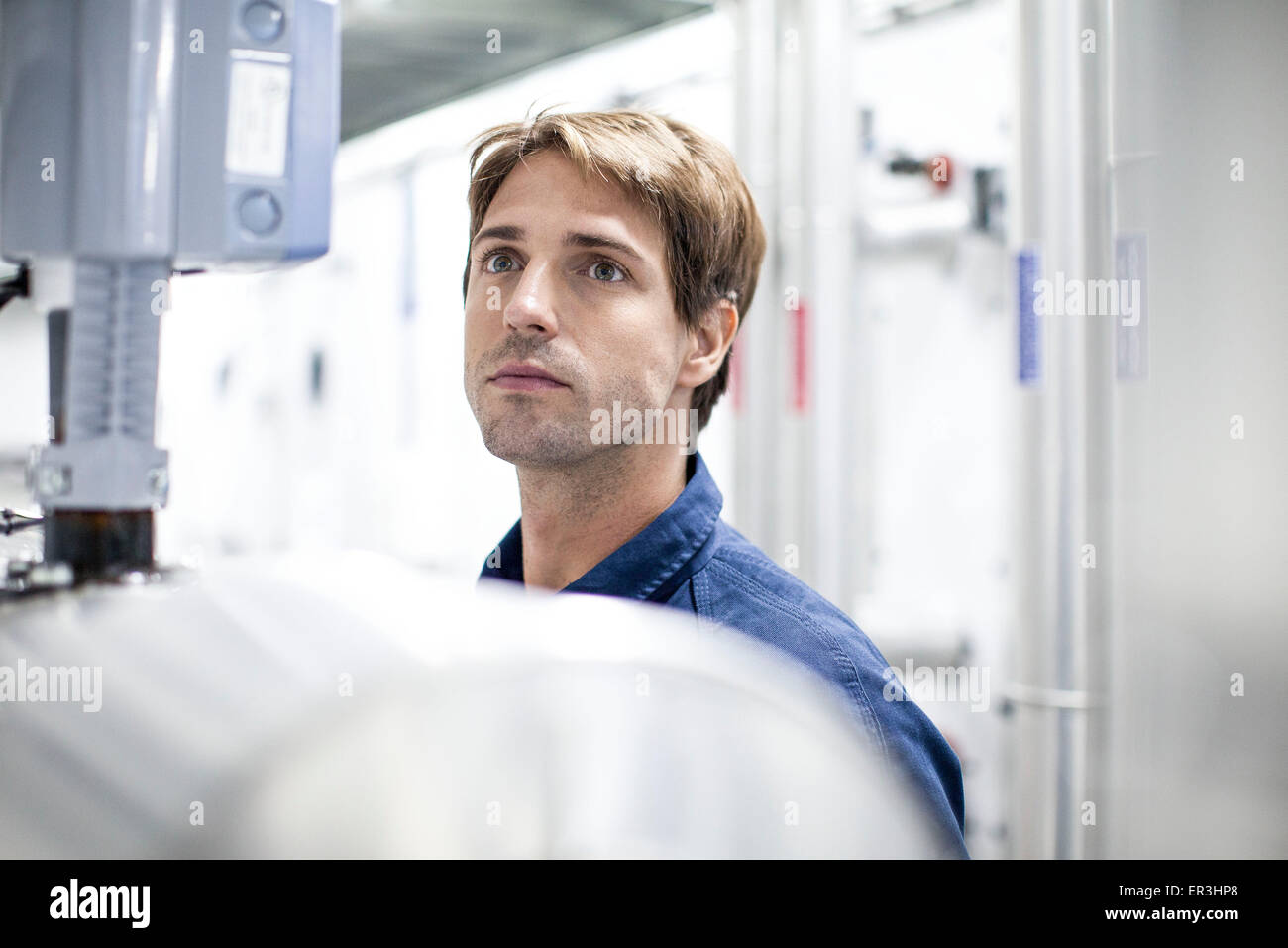 Worker at work in renewable energy production plant Stock Photo - Alamy