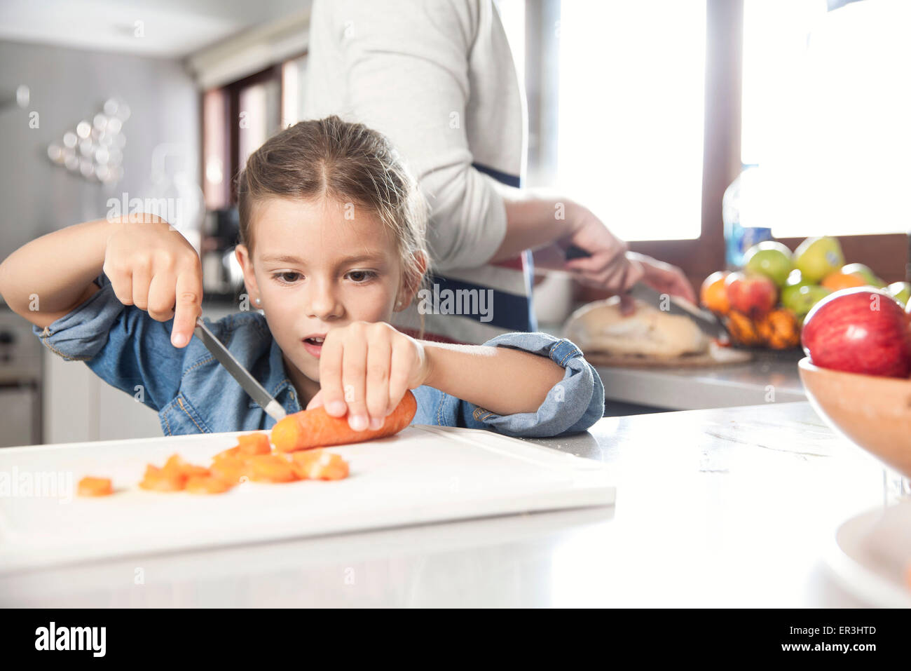 Little girl helping to prepare food in kitchen Stock Photo - Alamy