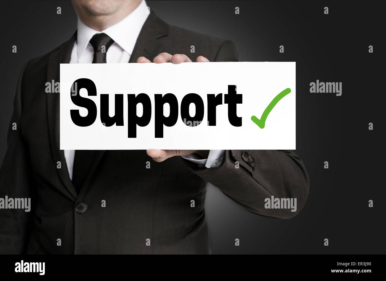 Support sign is held by businessman Stock Photo - Alamy