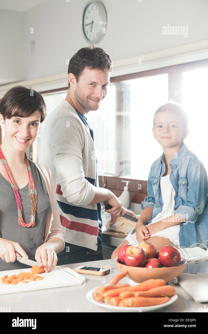 Family preparing food together in kitchen Stock Photo - Alamy