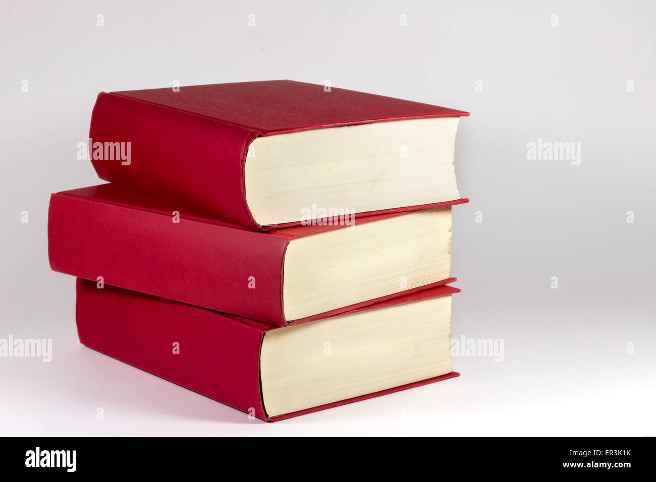 Three red books in white background Stock Photo - Alamy
