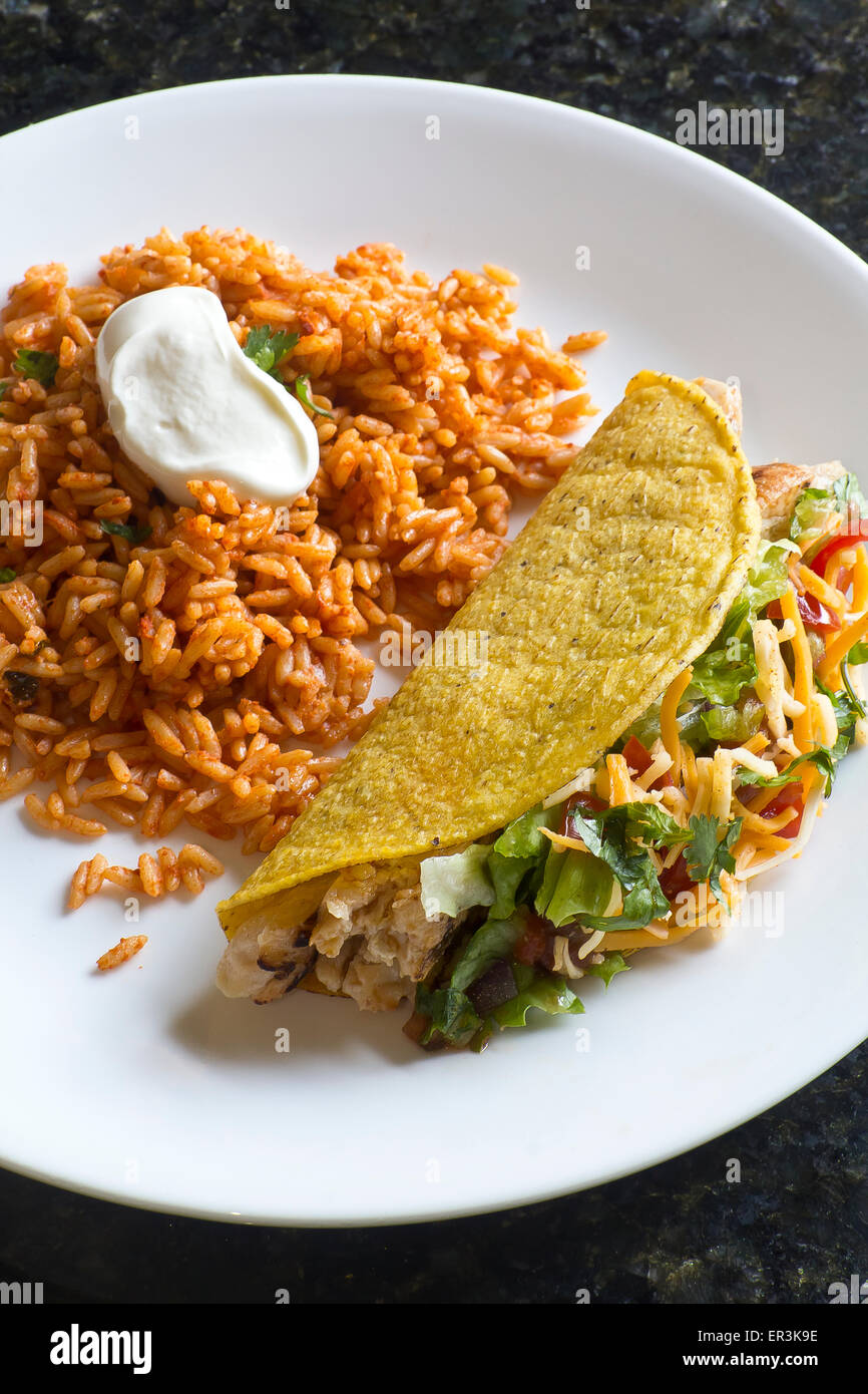 Chicken Hard Shell Taco with Mexican rice and sour cream Stock Photo ...
