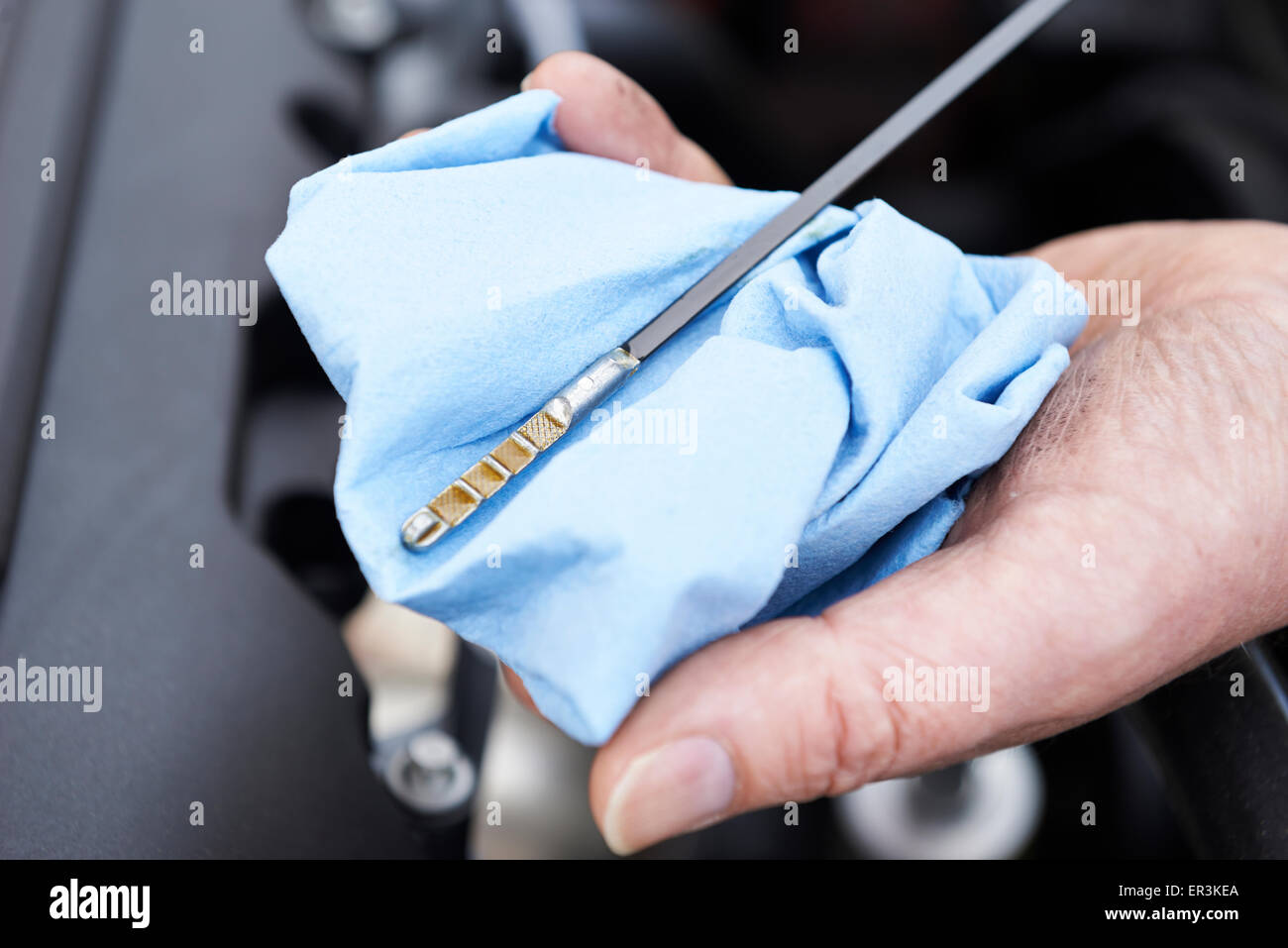 Close-Up Of Man Checking Car Engine Oil Level On Dipstick Stock Photo - Alamy