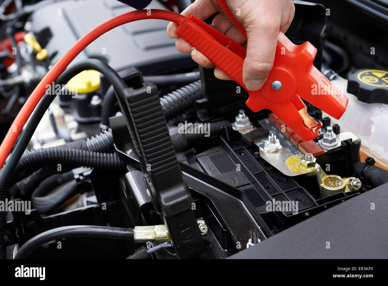 Close-Up Of Mechanic Attaching Jumper Cables To Car Battery Stock Photo ...