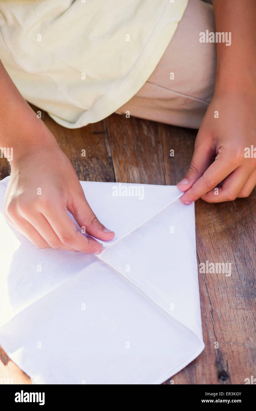 Child folding paper, cropped Stock Photo - Alamy