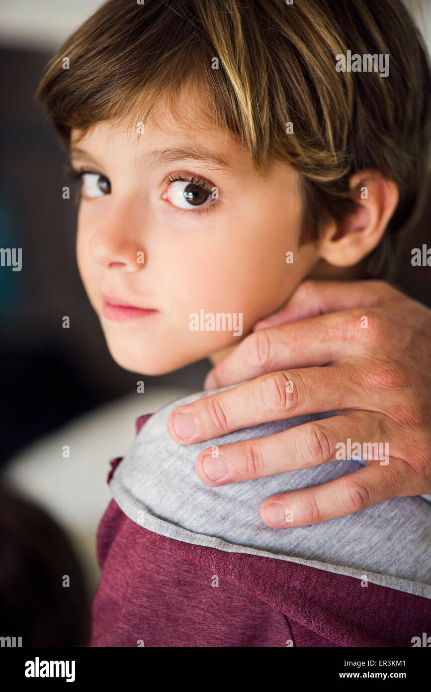 Parent's hand on boy's shoulder, cropped Stock Photo - Alamy