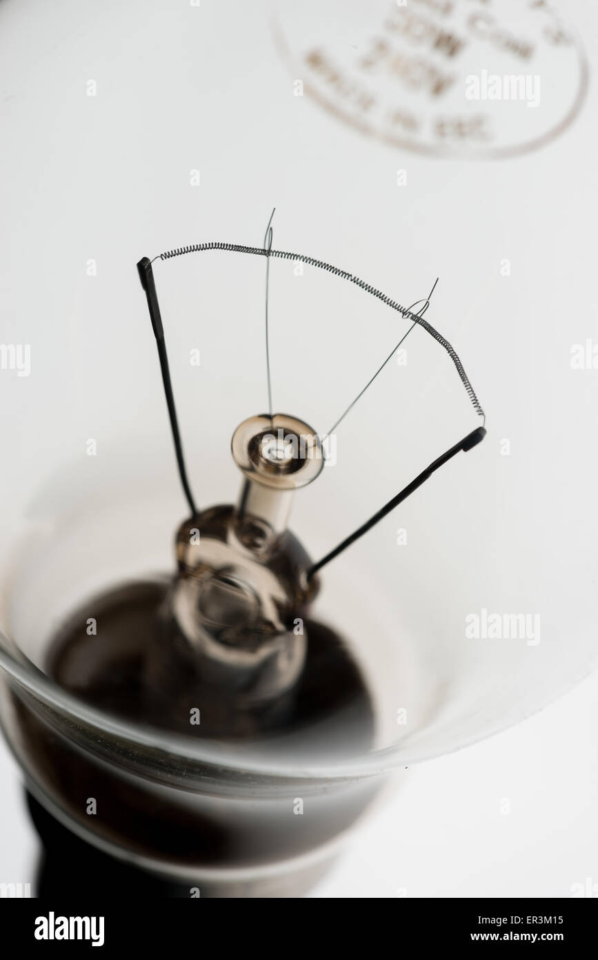 Tungsten wire filament in clear light bulb chamber indicating flow of ...