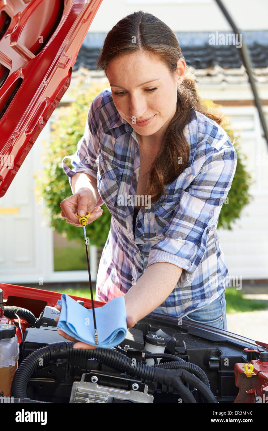 Woman Checking Car Engine Oil Level Under Hood With Dipstick Stock Photo - Alamy