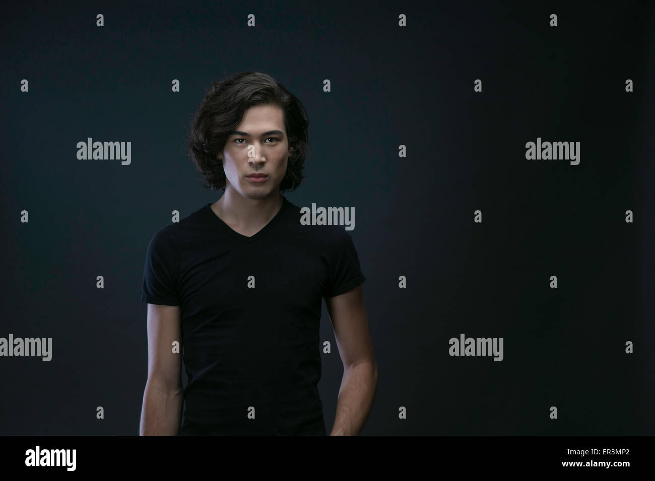 Portrait of male model in studio with dark colors, side light Stock ...