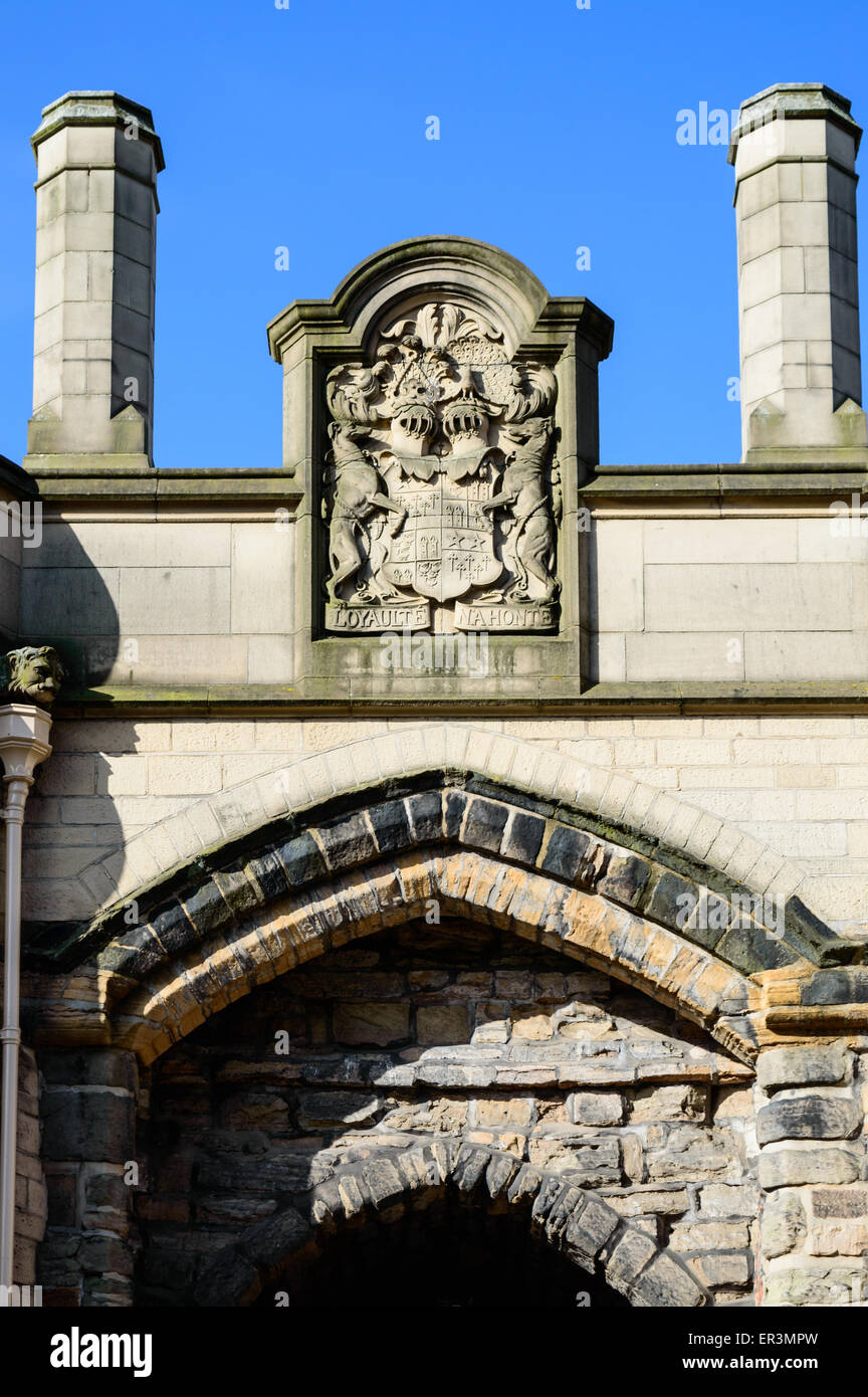 A coat of arms emblem carved above the archway of the gatehouse ...