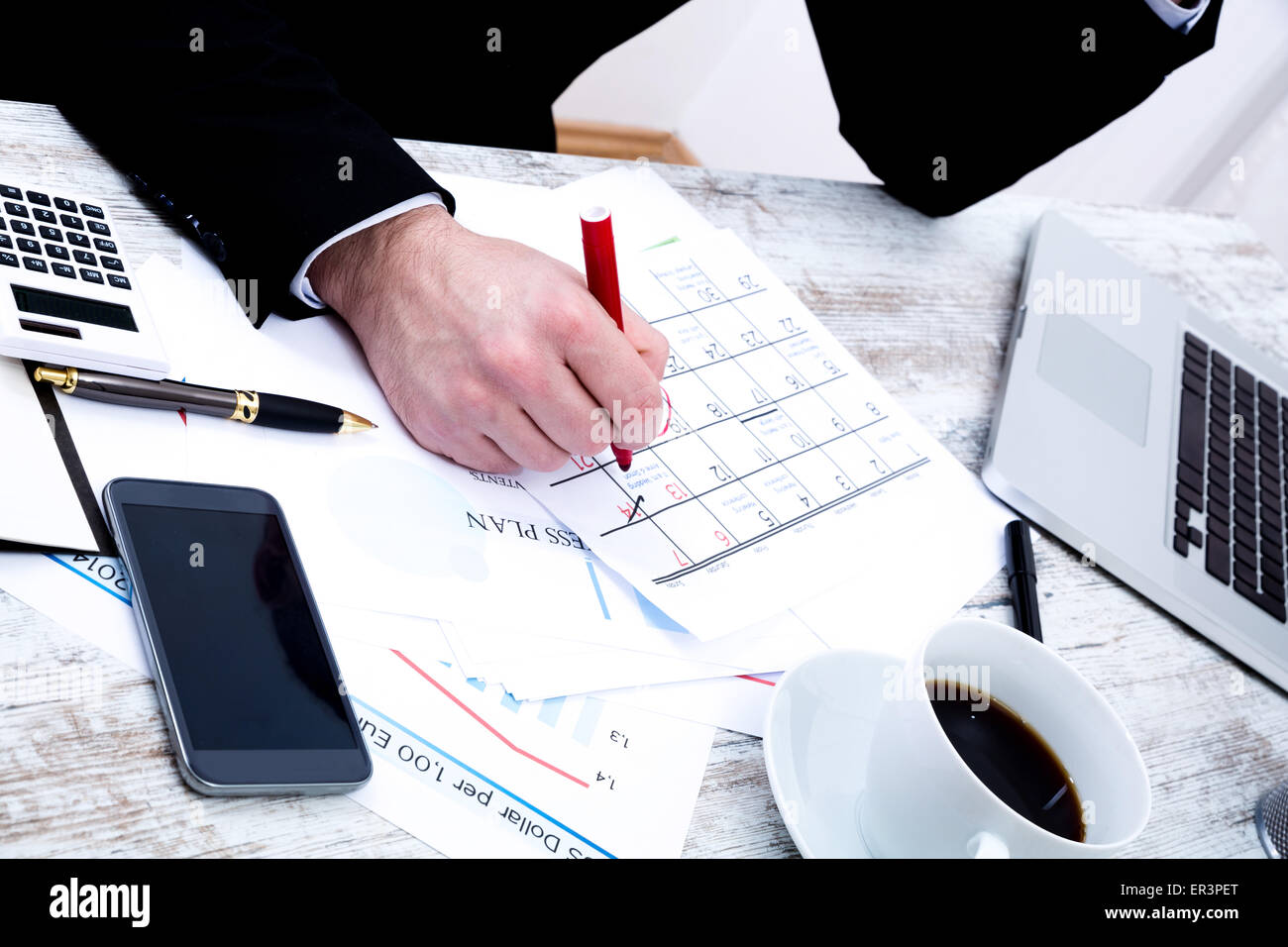 Businessman checking appointments in the calendar at the office Stock ...