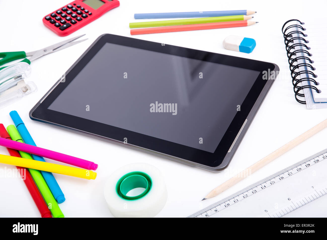 Doing some homework and using the tablet Stock Photo - Alamy