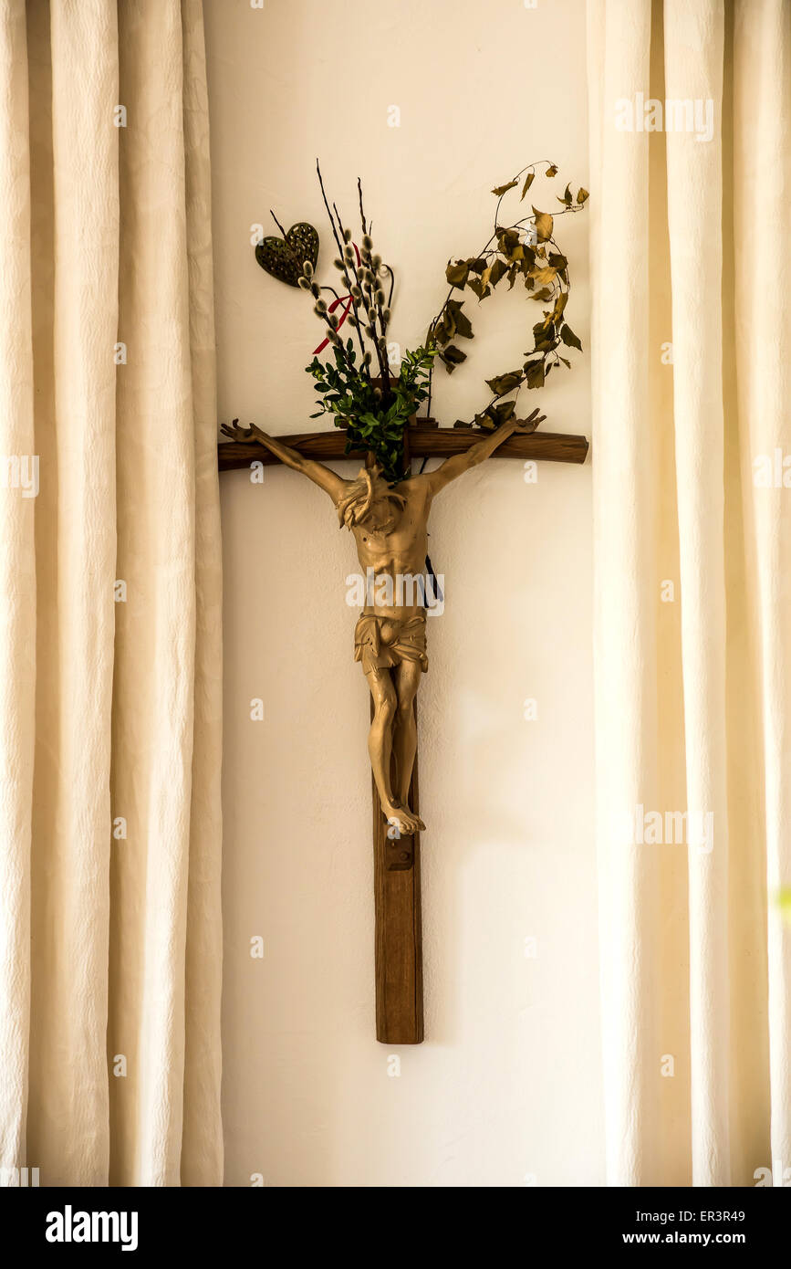 An old crucifix hanging on the wall Stock Photo - Alamy