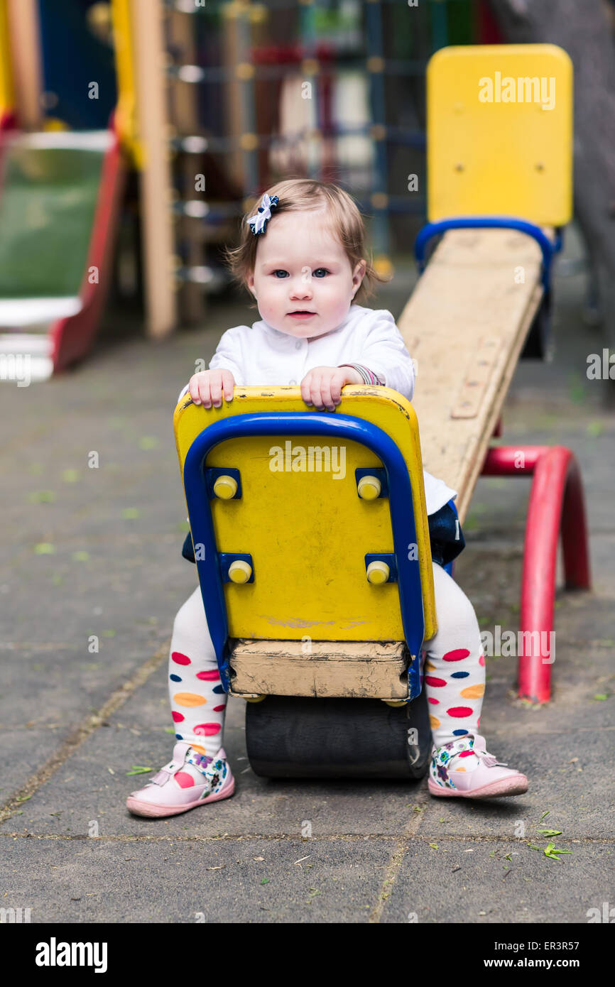 Baby toddler playing seesaw hi-res stock photography and images - Alamy