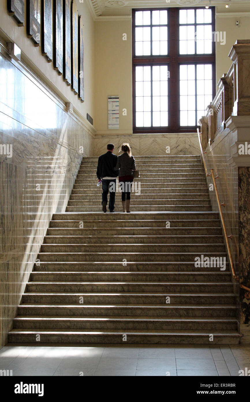 Couple walking up staircase inside Victoria and Albert Museum (V&A) in ...