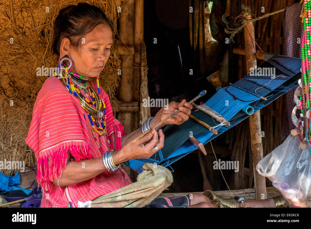 Woman from Palong tribe with traditional clothes, working on a loom ...