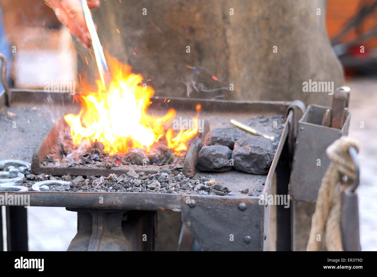Craftsman working with fire beating iron Stock Photo - Alamy