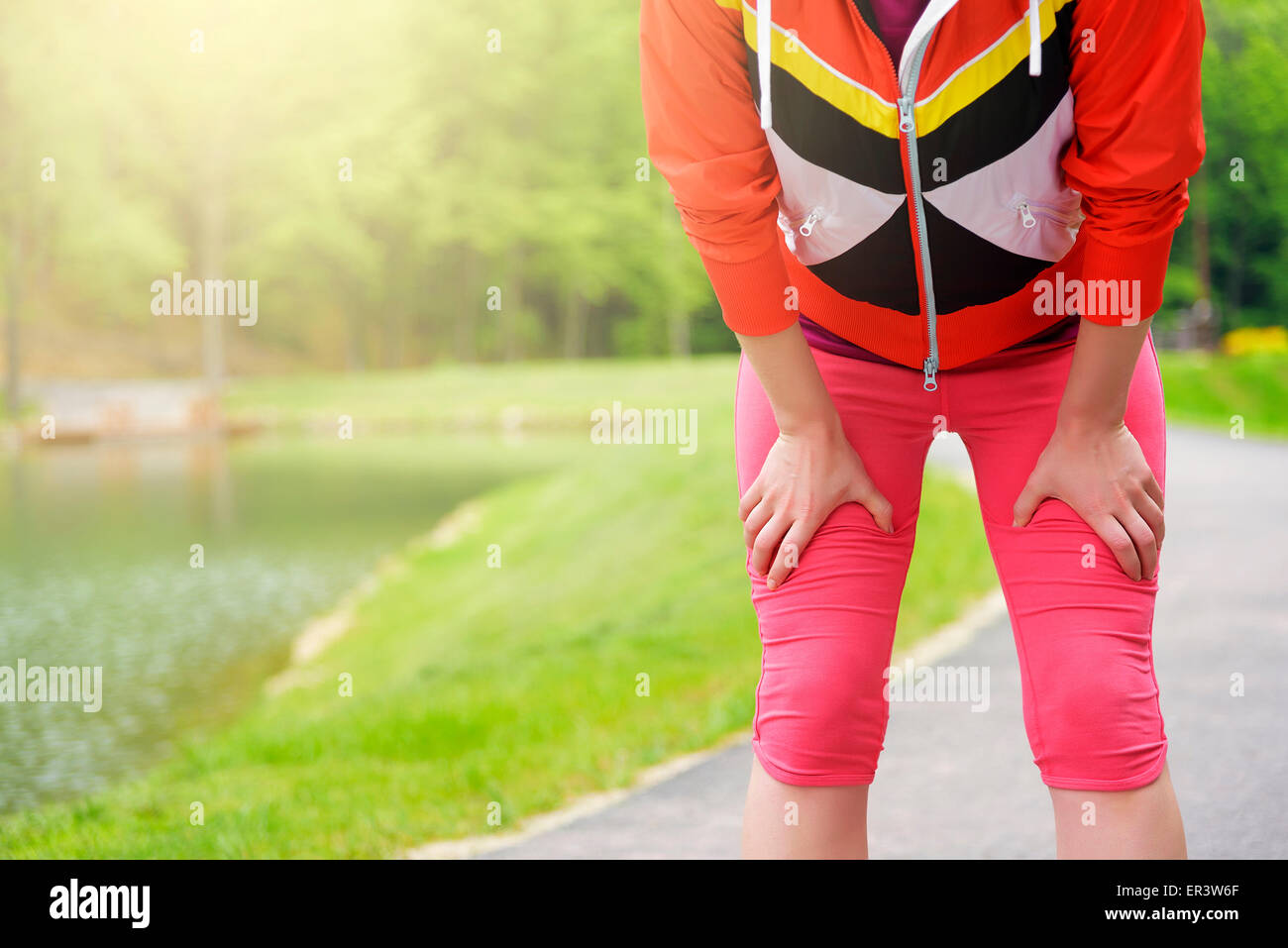 Tired female runner Stock Photo - Alamy