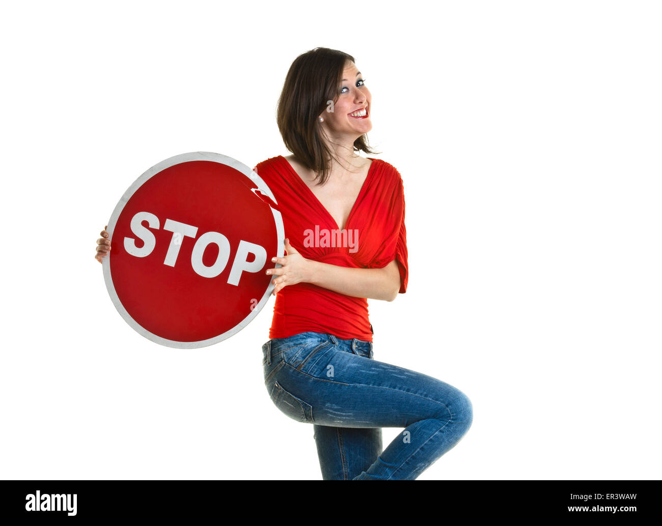 Beautiful young woman with red top and jeans holding a stop sign Stock ...