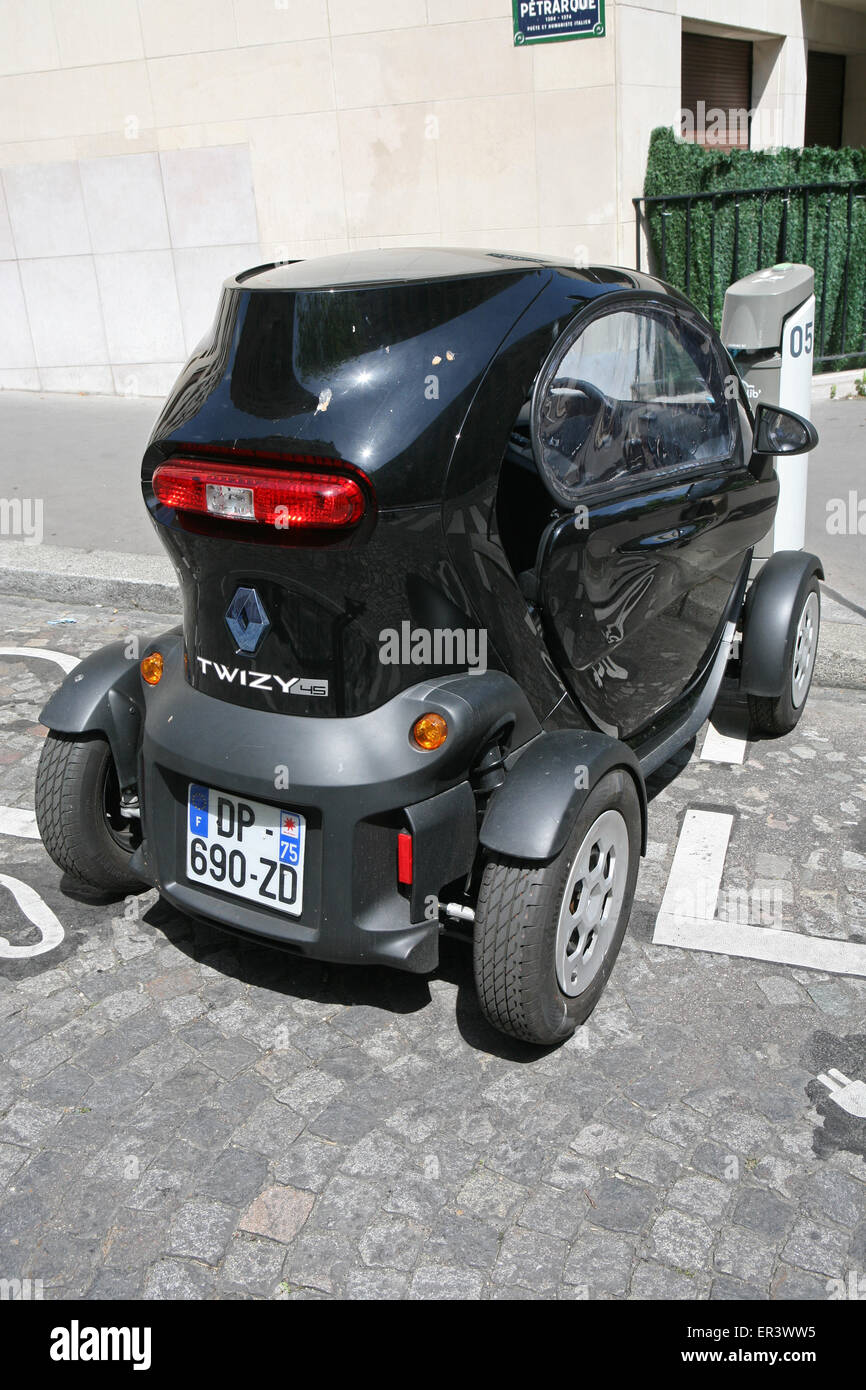 Twizzy electric car recharging in a street in Paris France Stock Photo ...