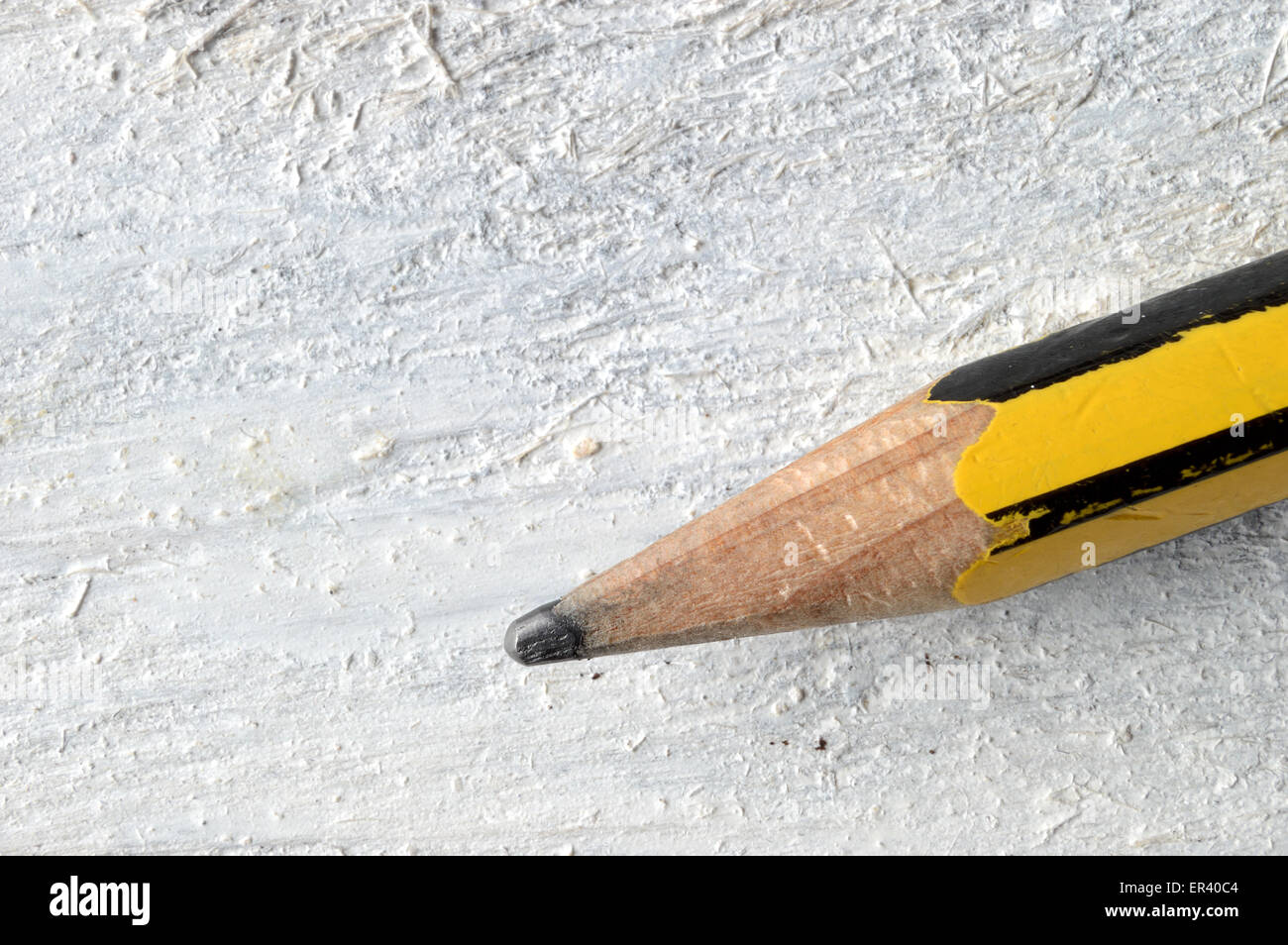 A pencil on a white wooden table Stock Photo - Alamy