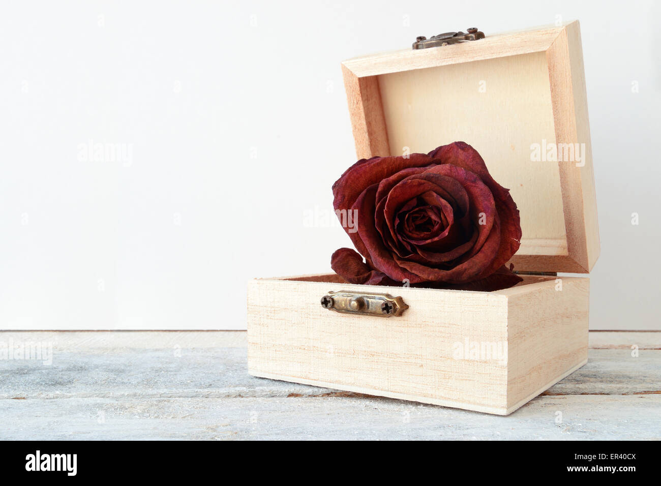 Withered red rose flower in a secret box Stock Photo - Alamy