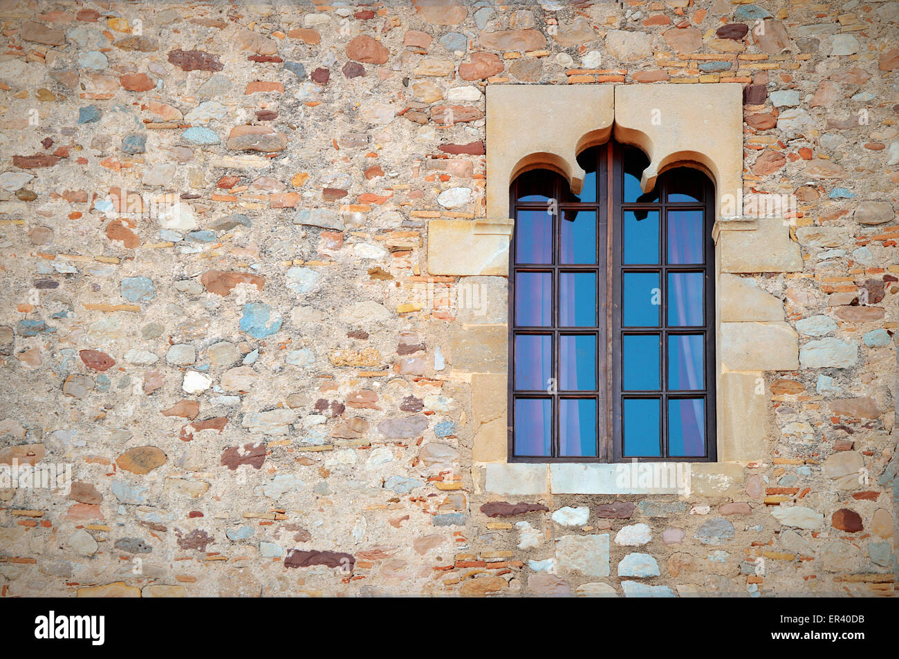 Old stone wall with a decorated window from an European castle, Middle ...