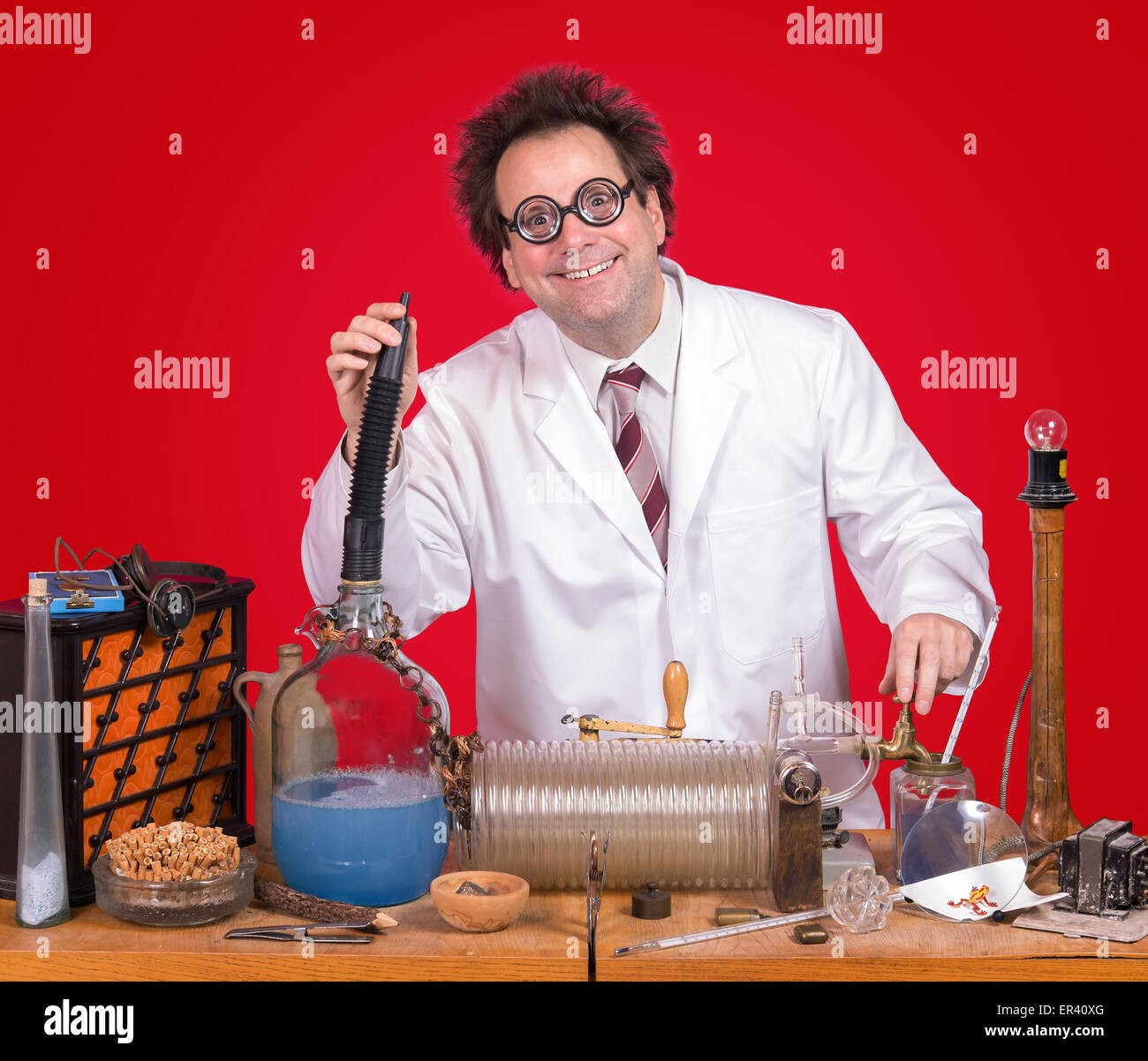 inventor at his desk with equipment on red background Stock Photo - Alamy