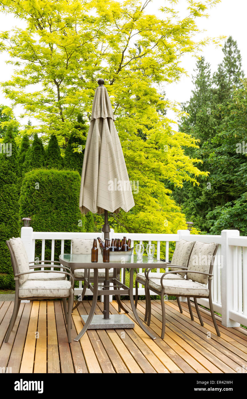 Vertical photo of outdoor patio table with cold bottled beer in bucket ...
