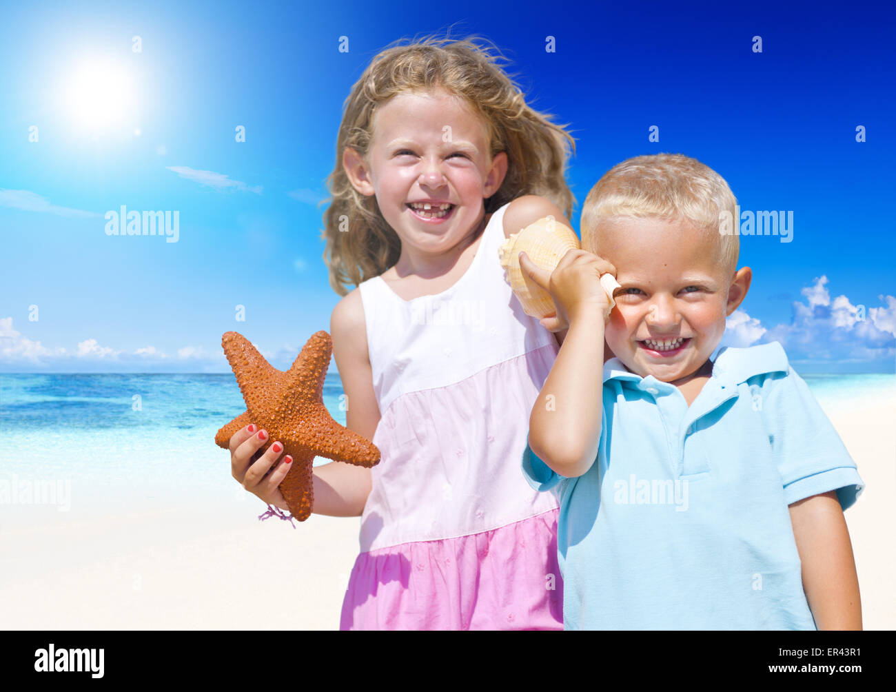 Brother And Sister Having Fun On Beach High Resolution Stock ...