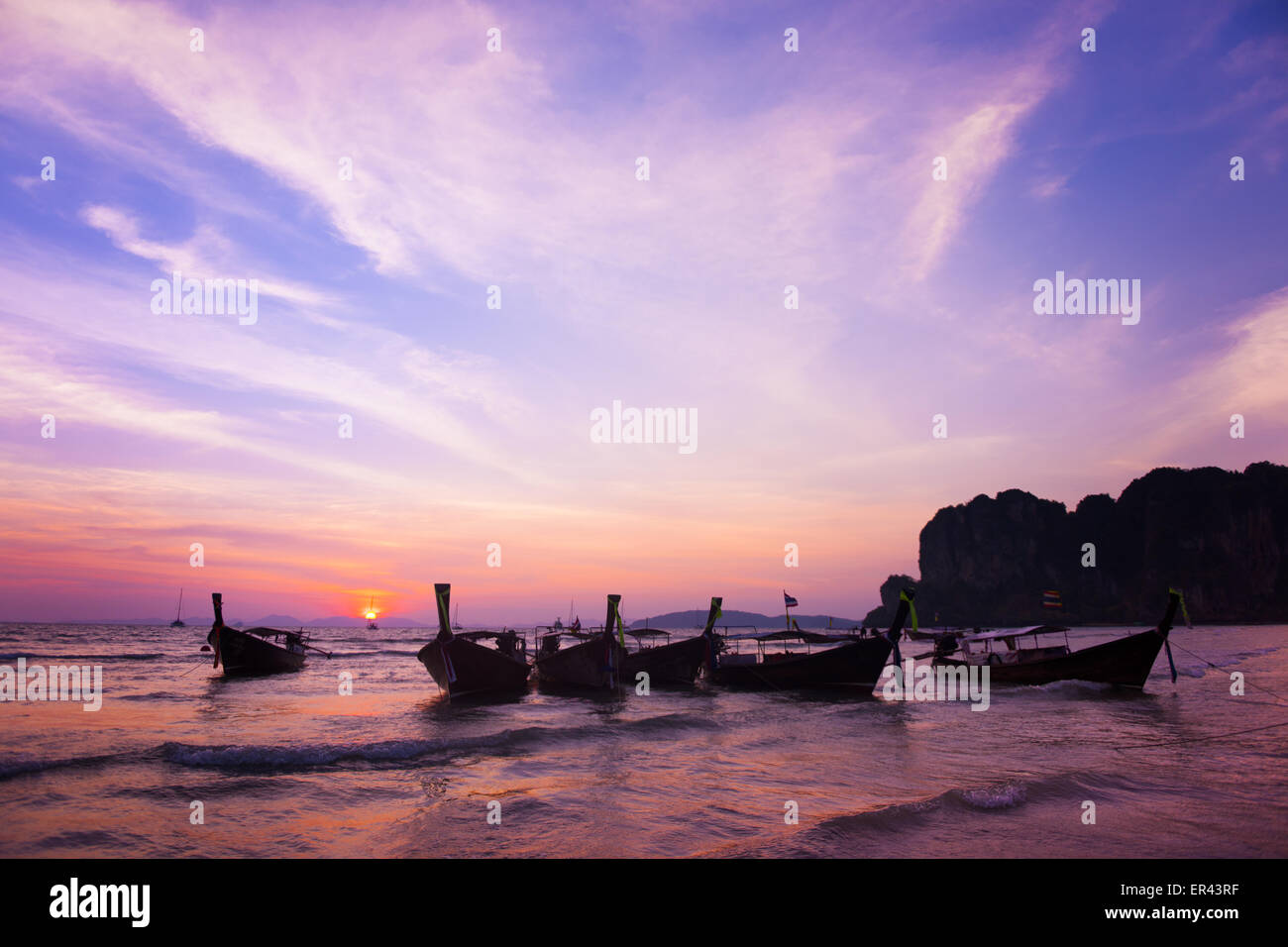 Multiple boats in sunset Stock Photo - Alamy
