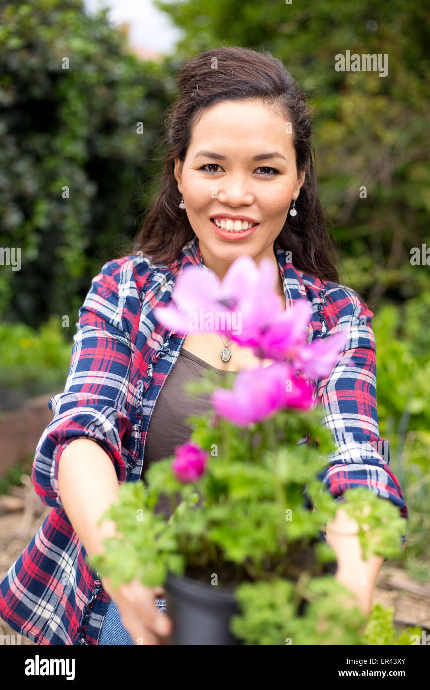 young woman giving a flower pot Stock Photo - Alamy