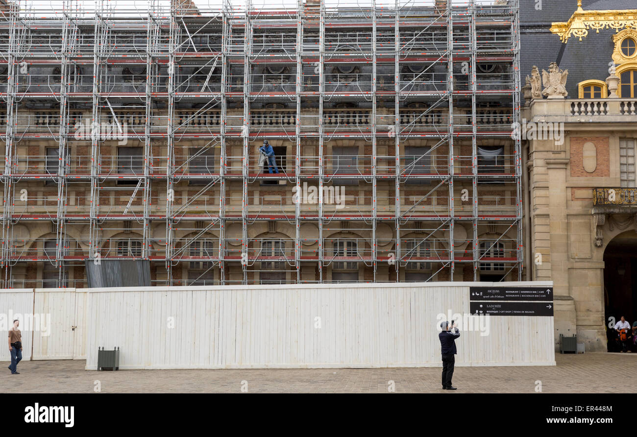 A worker with restoration and preservation scaffolding setting up on ...