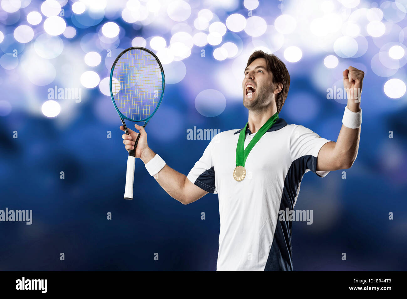 Tennis player celebrating with a gold medal, on a blue lights ...