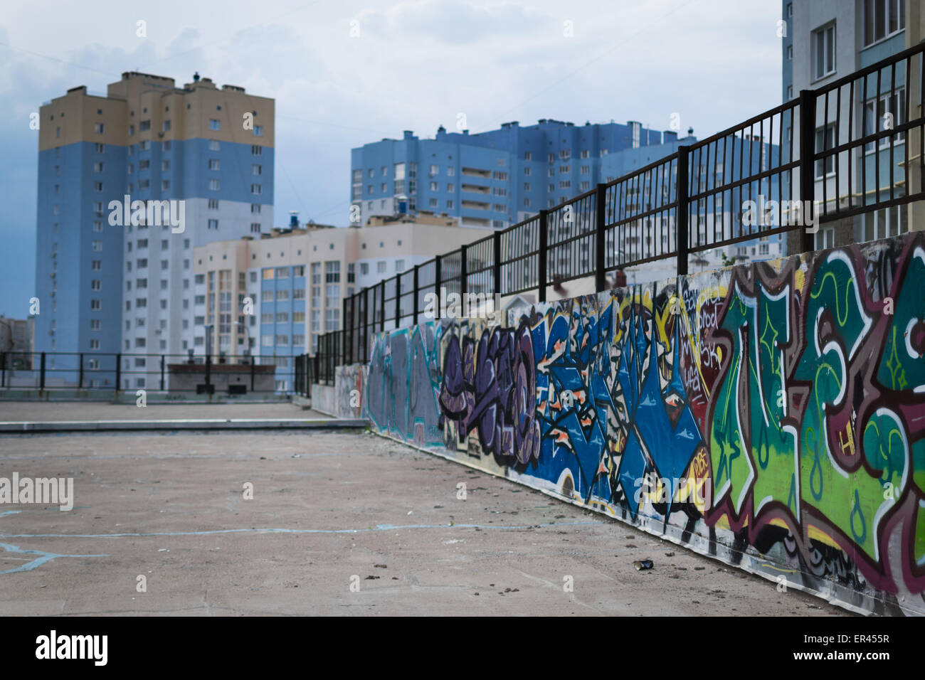 Modern street art painted on concrete with high-rise apartments in ...
