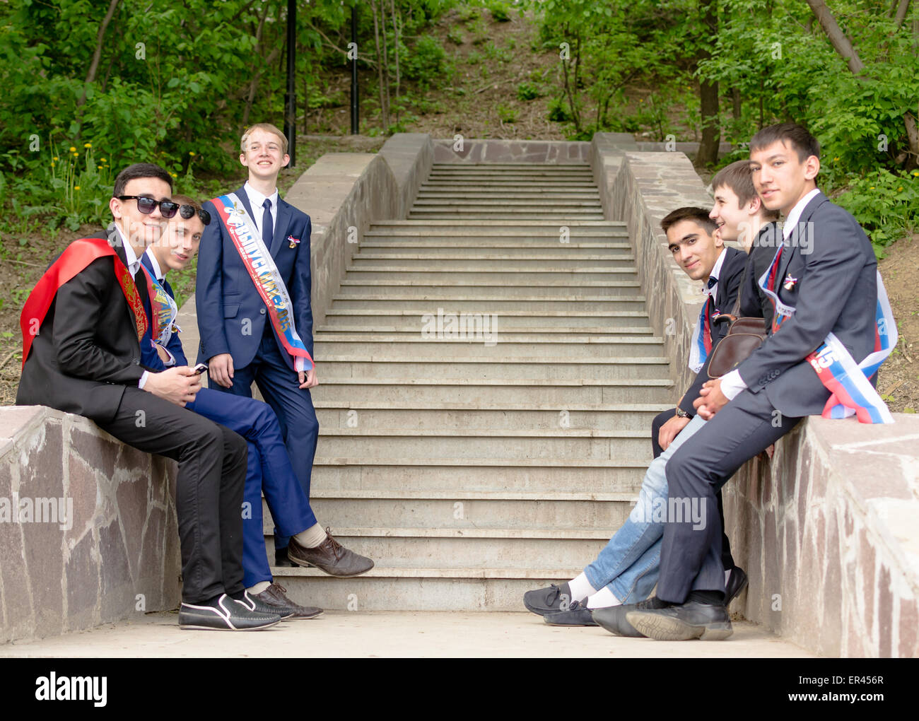 Group of 6 Russian school kids relaxing after graduation from high ...