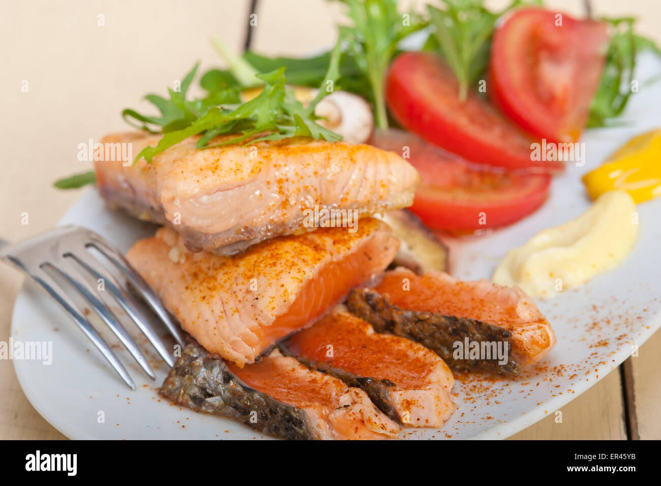 grilled fresh samon filet with vegetables salad tomato arugula ...