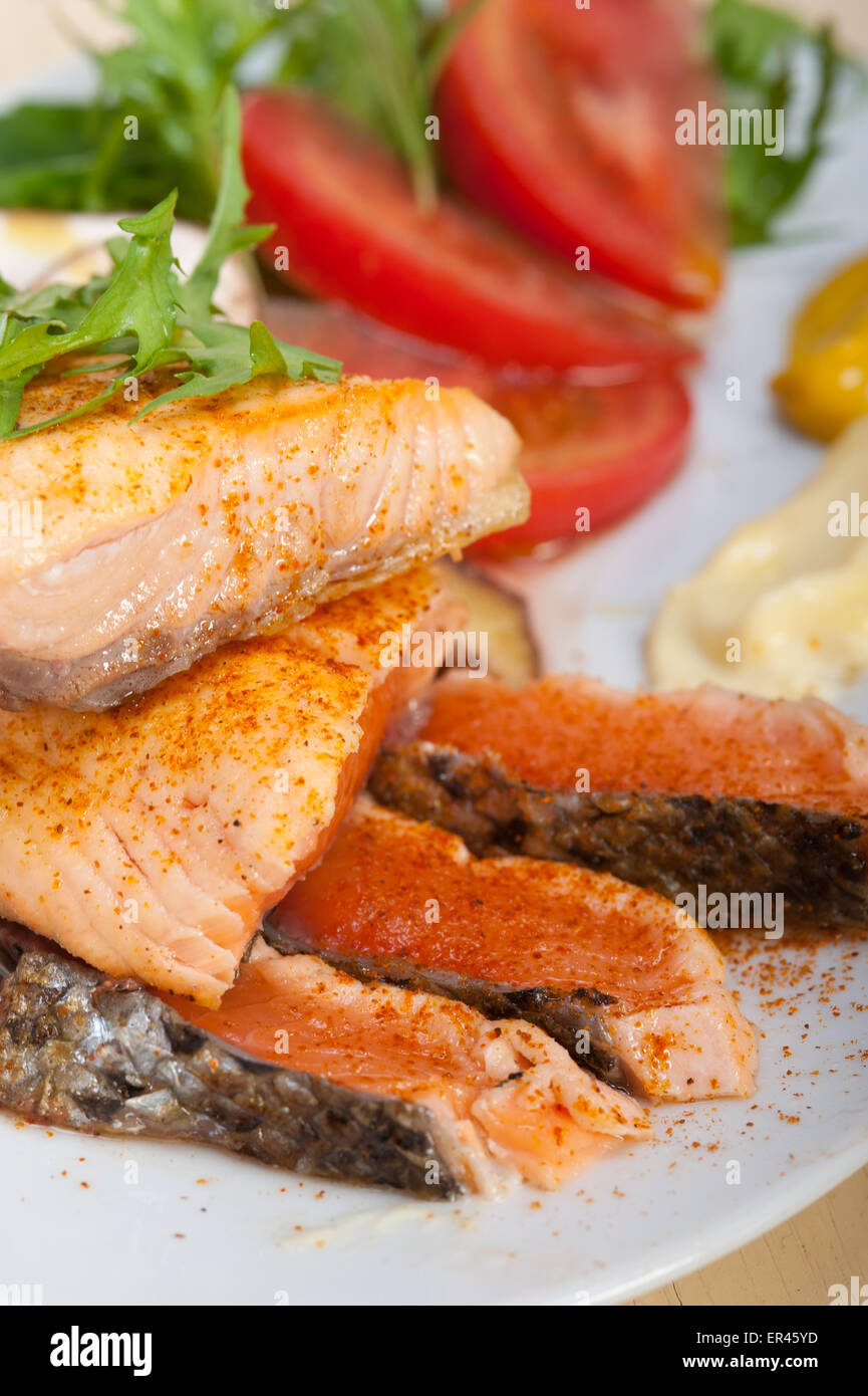 grilled fresh samon filet with vegetables salad tomato arugula ...