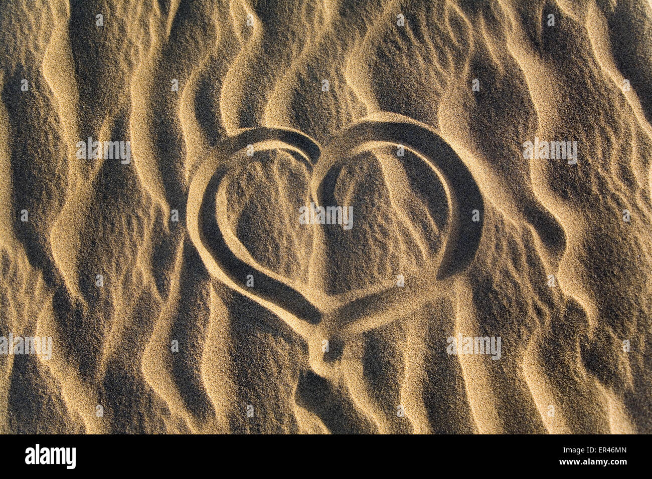 Heart drawing on dry sand Stock Photo - Alamy
