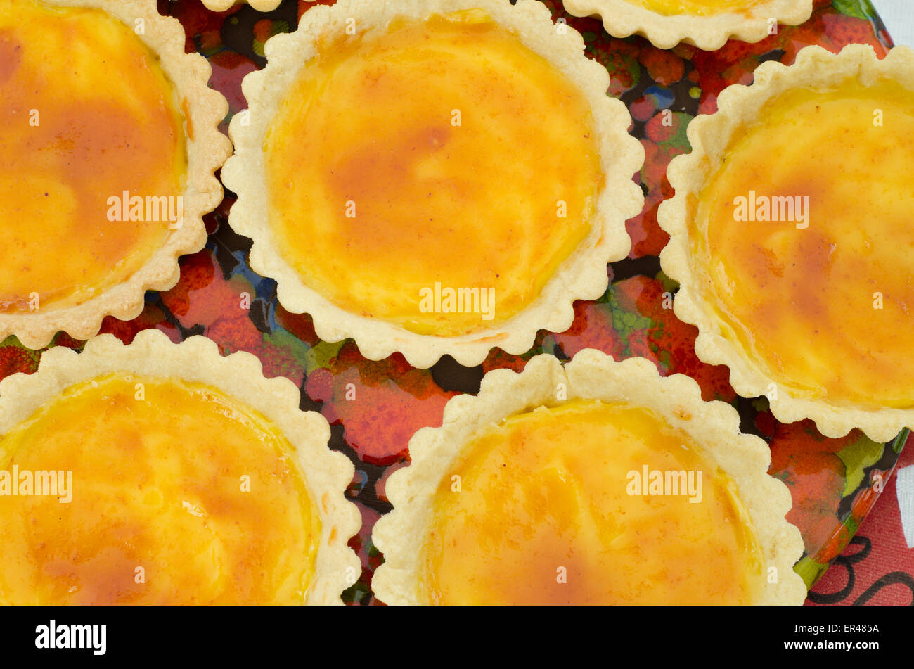 Round orange tarts on the red plate Stock Photo - Alamy