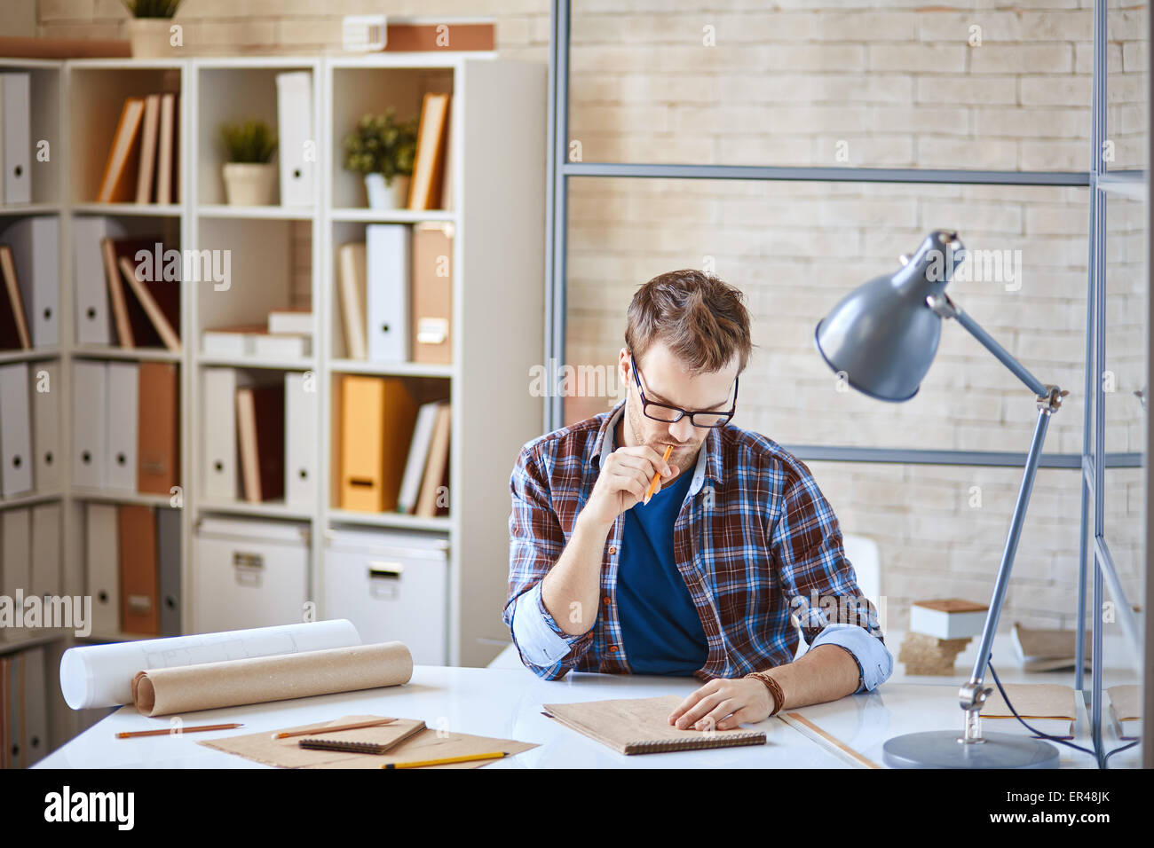 Young architect making sketches at workplace Stock Photo - Alamy