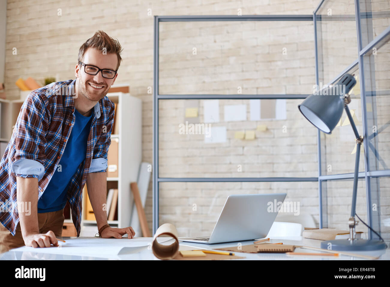Happy architect looking at camera in office Stock Photo - Alamy
