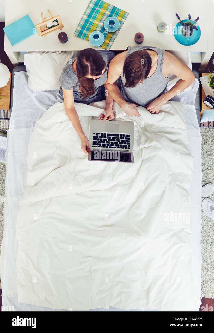 Young couple networking in bed Stock Photo - Alamy