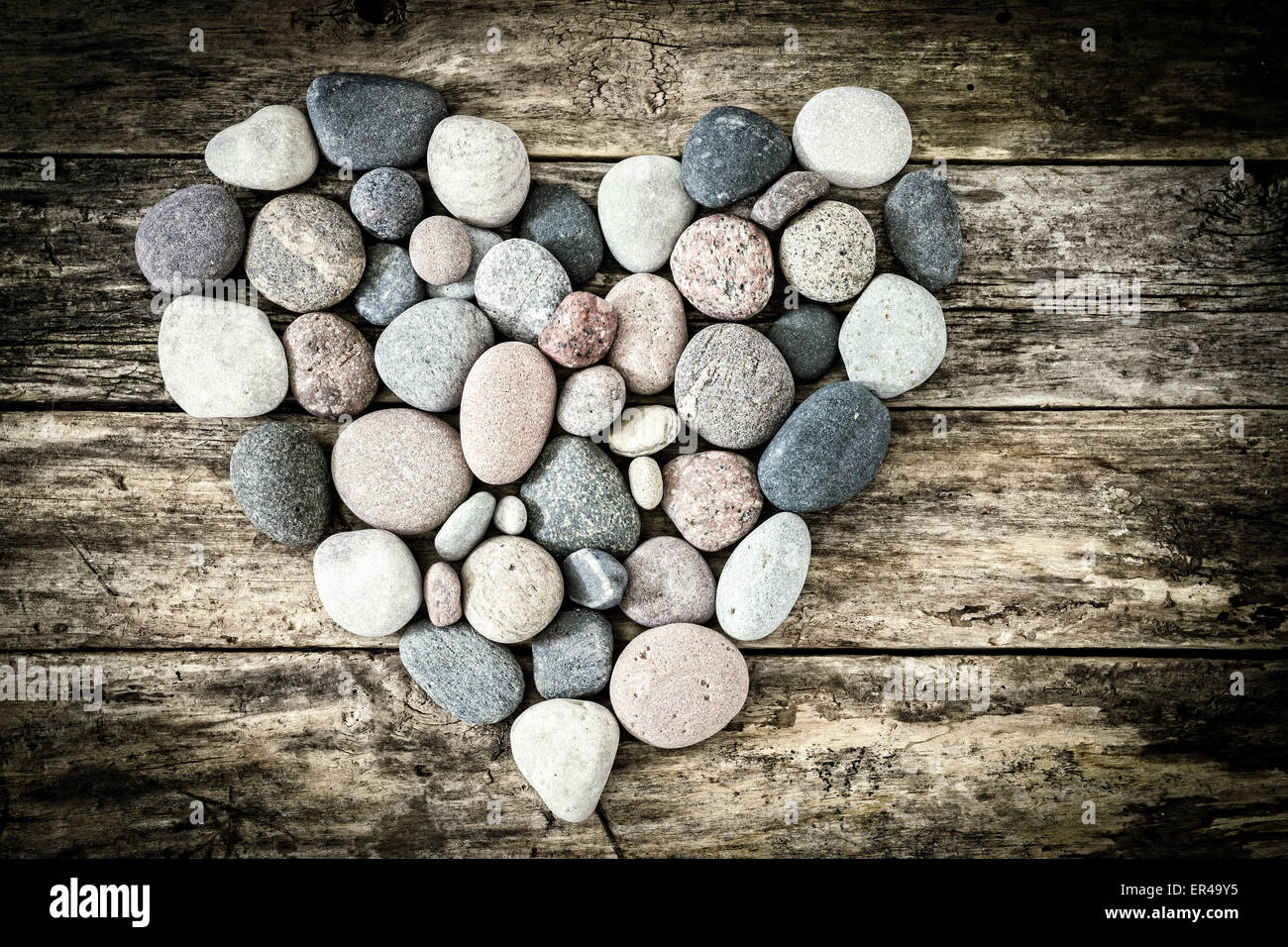 Stone heart on a wooden background Stock Photo - Alamy