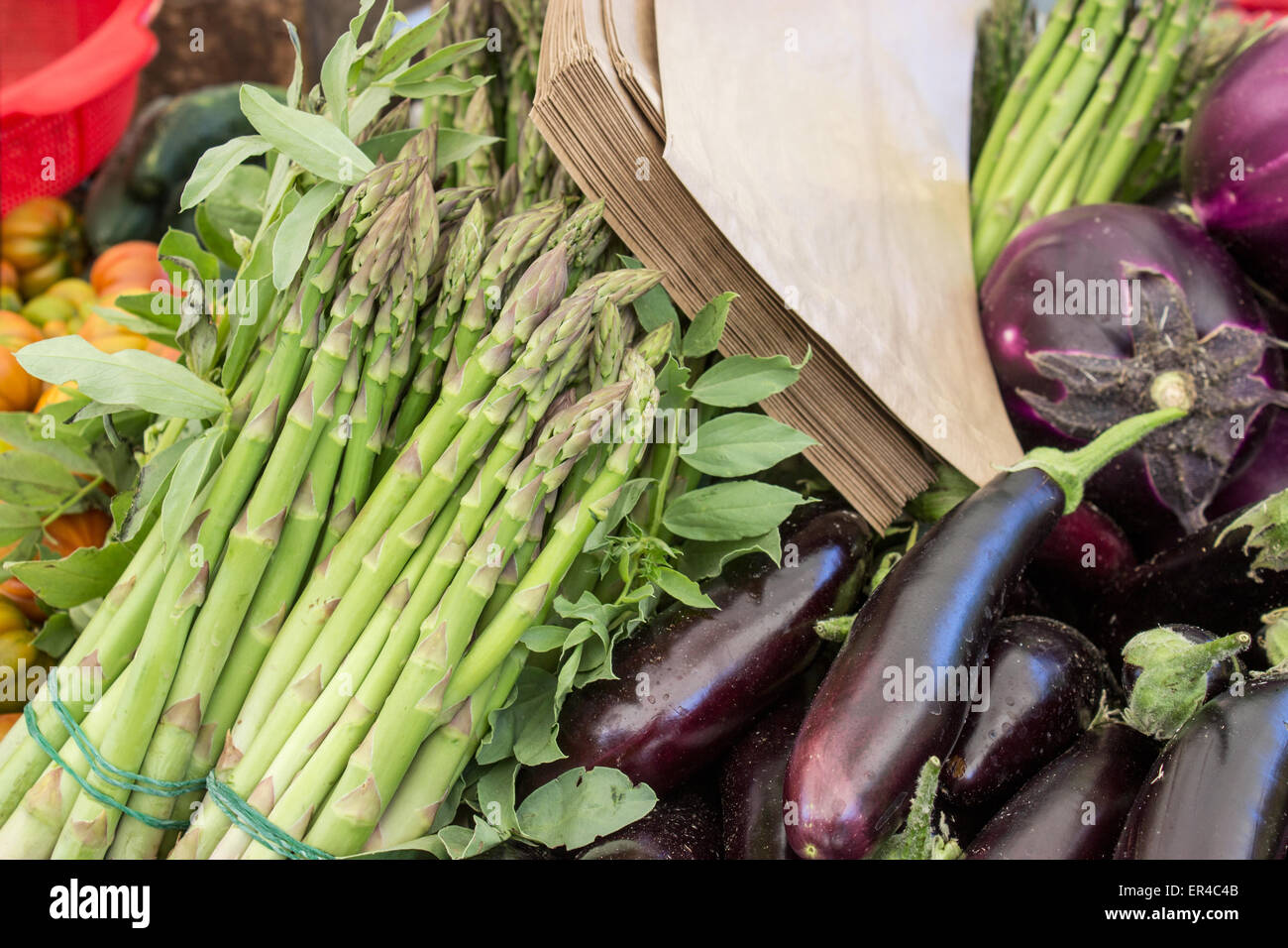 Display with fresh green asparagus and aubergine Stock Photo - Alamy