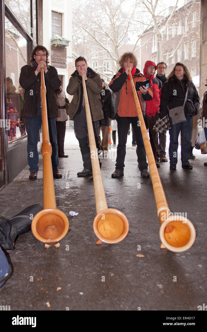 Three people playing alpine horn's in Dusseldorf, Germany Stock Photo ...