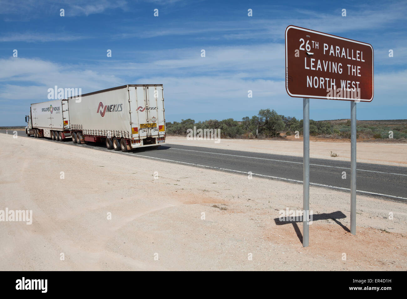 Signpost telling people they are passing the 26th Parallel in Western ...