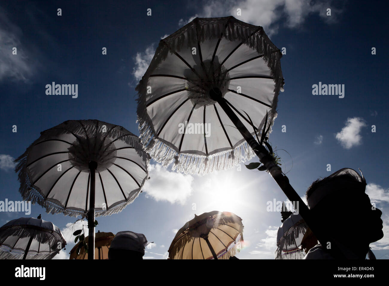 Procession of Umbrellas during a ceremony at Tanah Lot temple near the ...