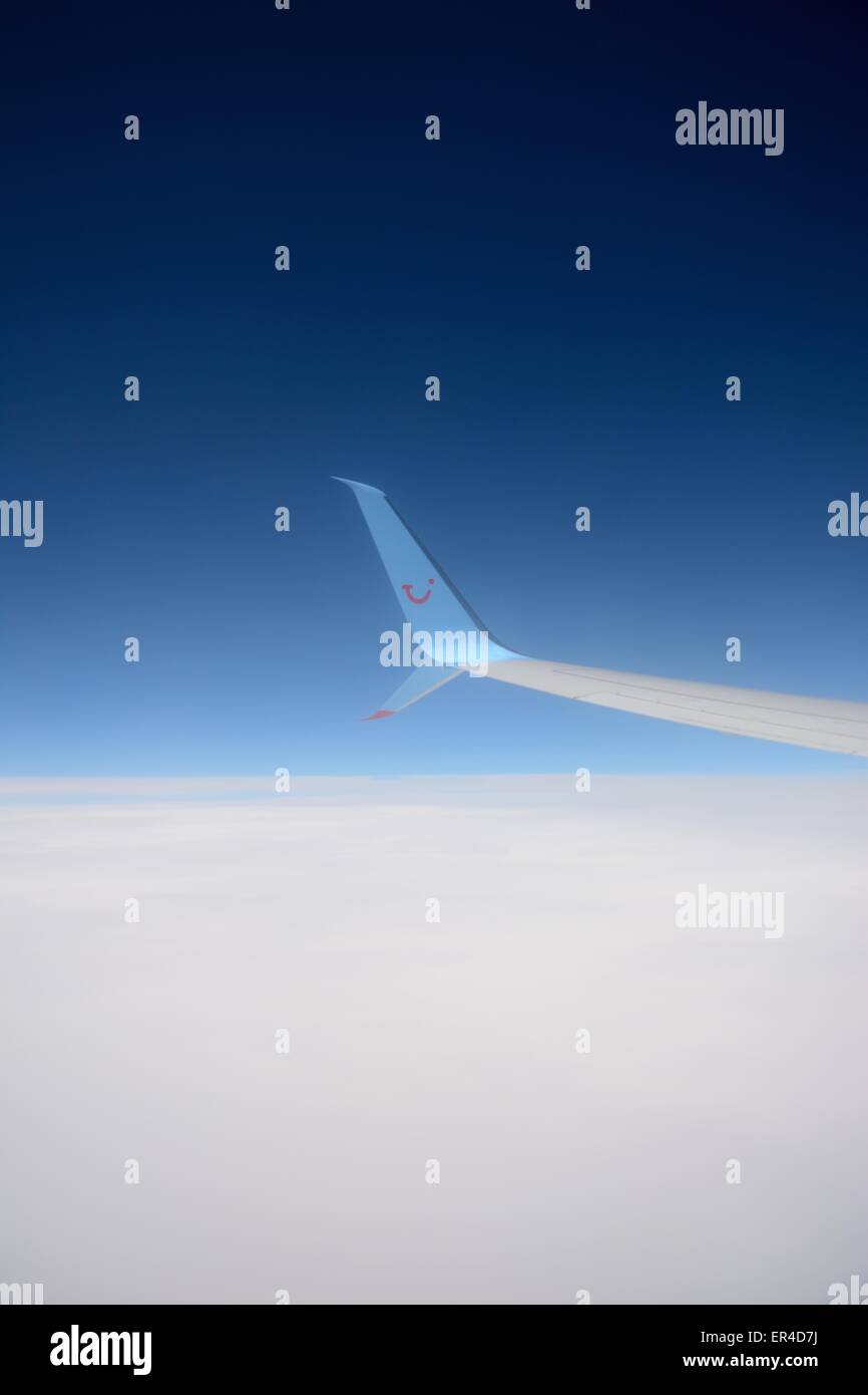 TUI aircraft wing flight above clouds with blue sky Stock Photo - Alamy