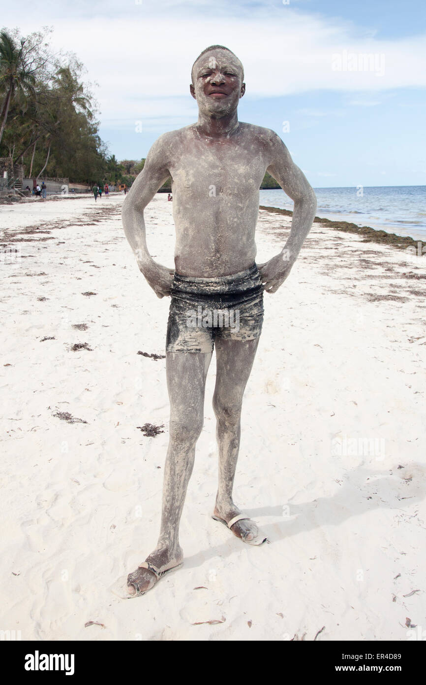 A boy covers his body in sand after swimming in the sea Stock Photo - Alamy